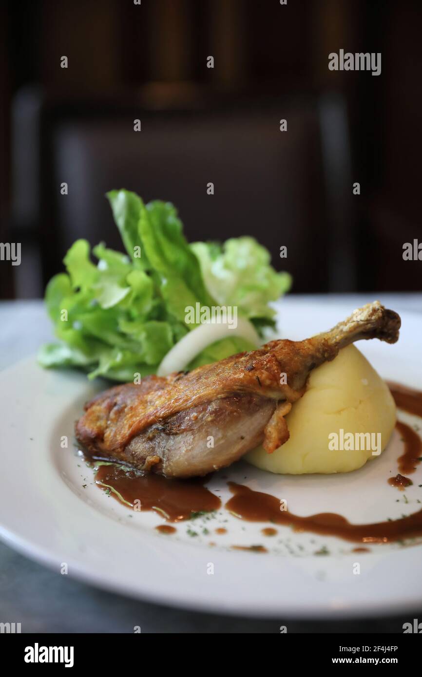 confit de canard , Duck confit with vegetable Stock Photo - Alamy
