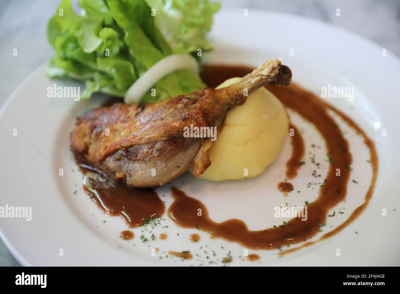 confit de canard , Duck confit with vegetable Stock Photo - Alamy