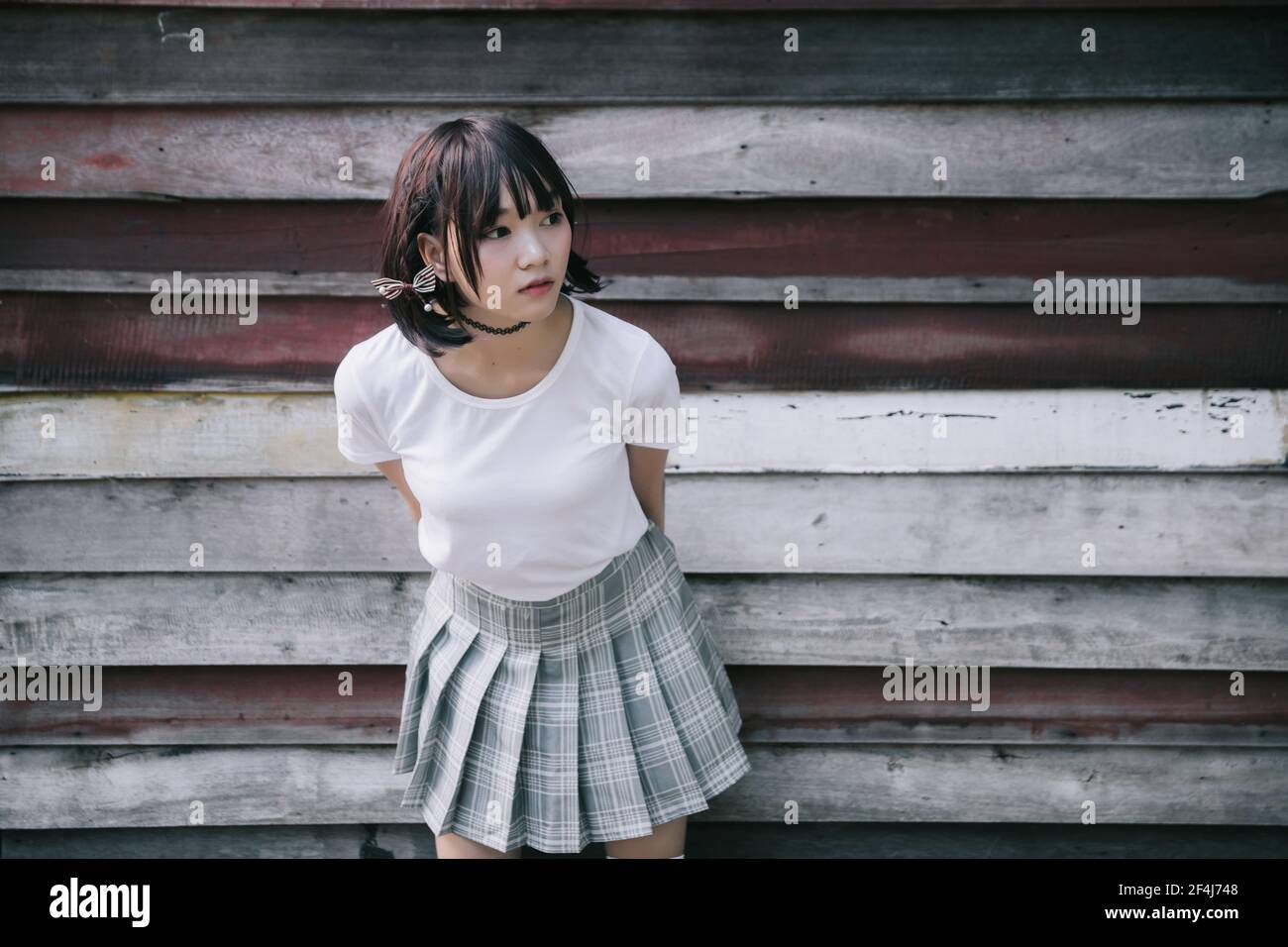 portrait of asian girl with white shirt and skirt looking in outdoor ...