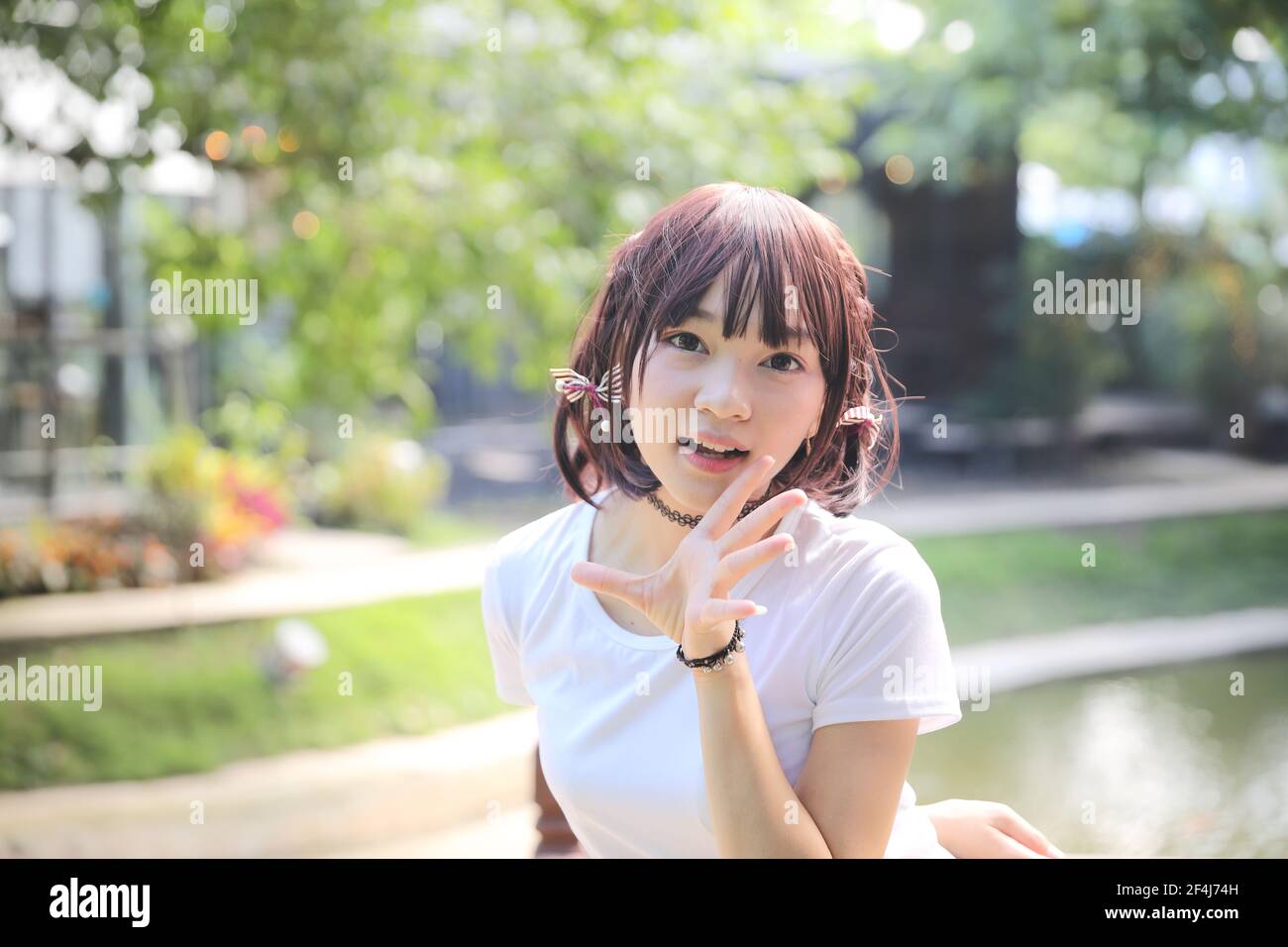 Portrait beautiful asian girl shouting and smile in nature leaves ...