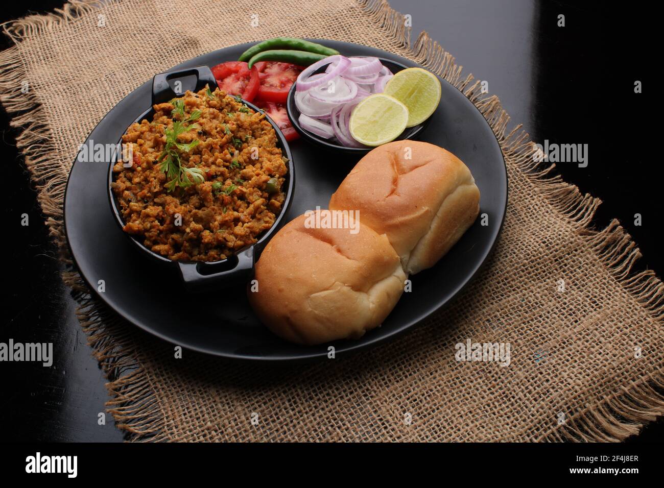 Masala Anda Bhurji or Spicy Indian scrambled eggs with bread or Bun Pav ...