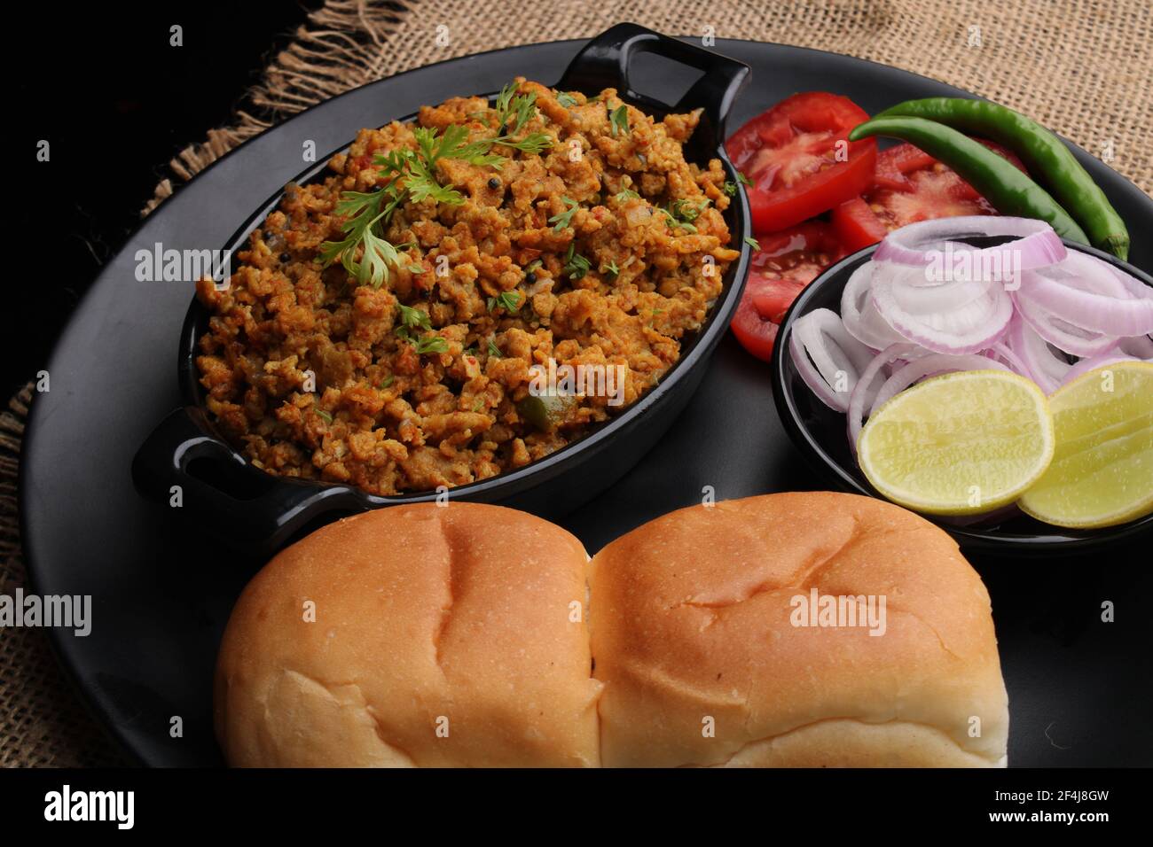 Masala Anda Bhurji or Spicy Indian scrambled eggs with bread or Bun Pav ...