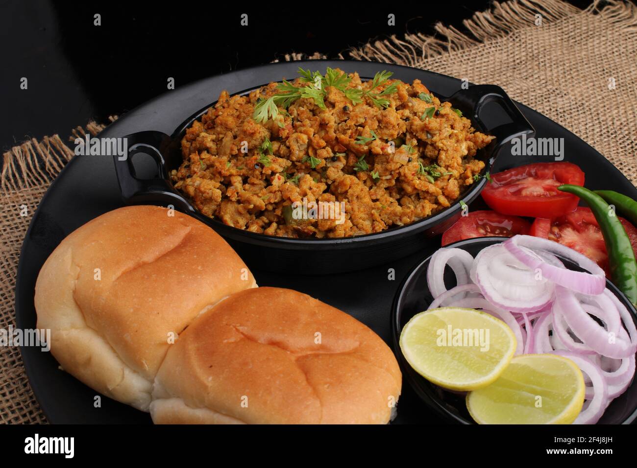 Masala Anda Bhurji or Spicy Indian scrambled eggs with bread or Bun Pav ...