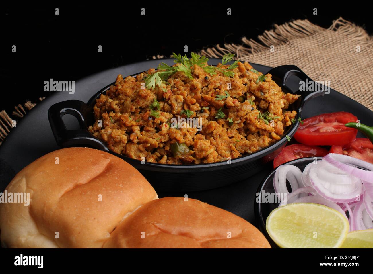 Masala Anda Bhurji or Spicy Indian scrambled eggs with bread or Bun Pav ...