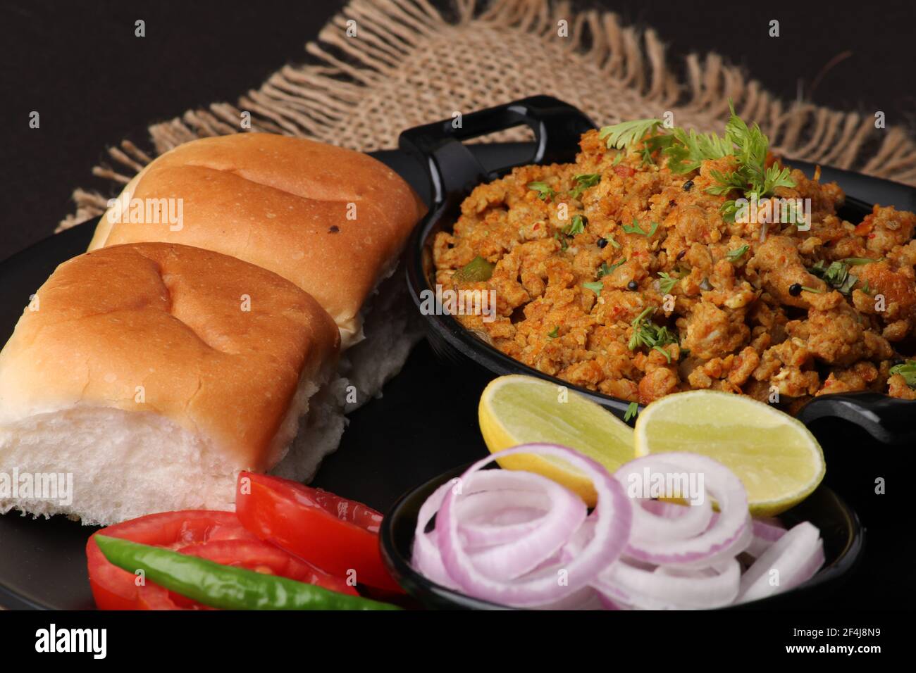 Masala Anda Bhurji or Spicy Indian scrambled eggs with bread or Bun Pav ...