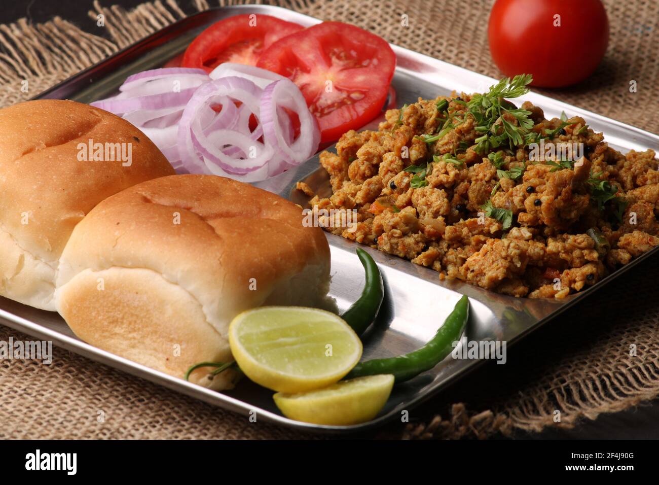 Masala Anda Bhurji or Spicy Indian scrambled eggs with bread or Bun Pav ...