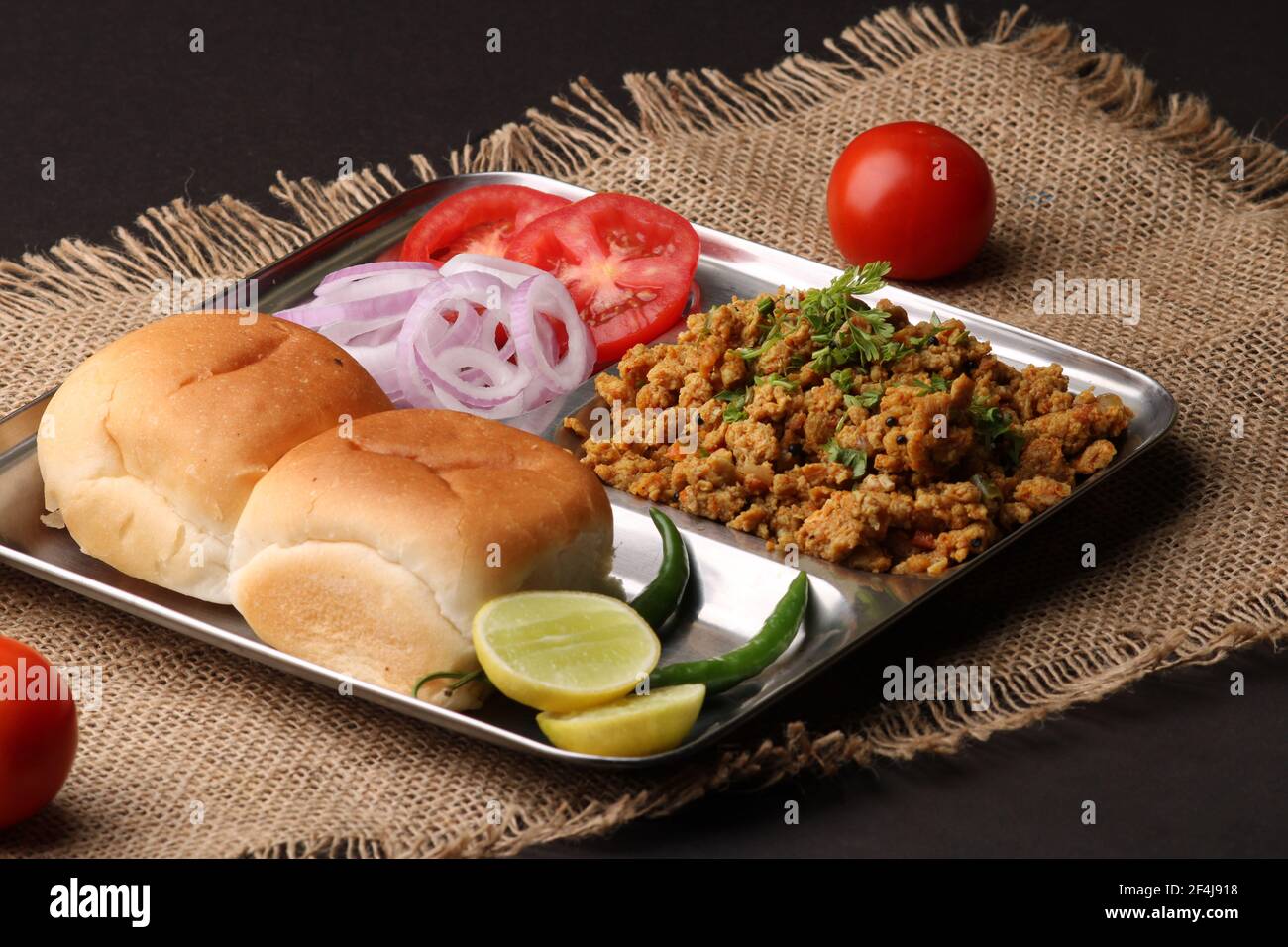 Masala Anda Bhurji or Spicy Indian scrambled eggs with bread or Bun Pav ...