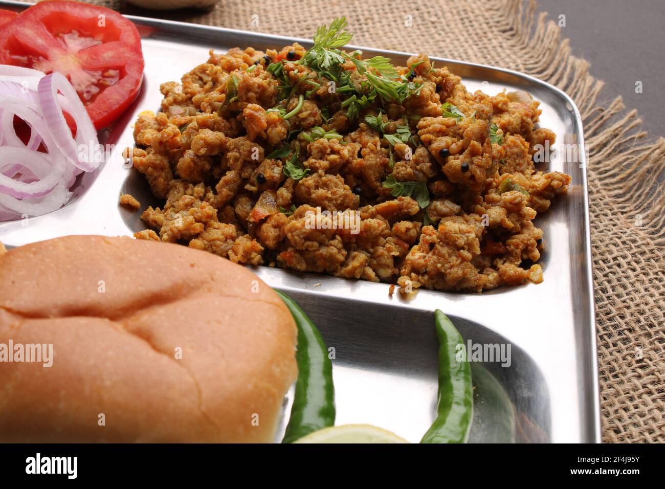Masala Anda Bhurji or Spicy Indian scrambled eggs with bread or Bun Pav ...