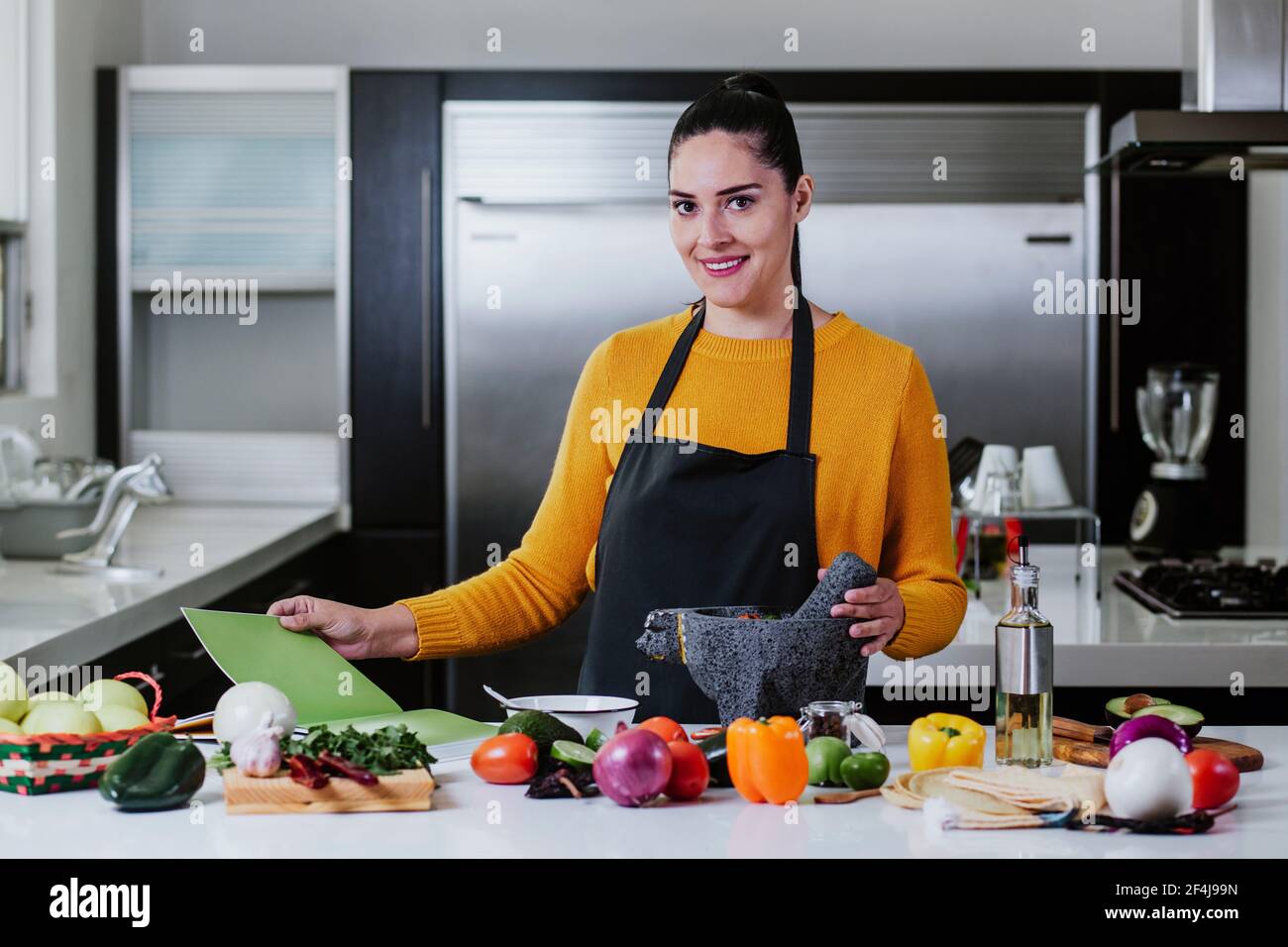 latin woman cooking mexican sauce food in kitchen at home in Mexico ...