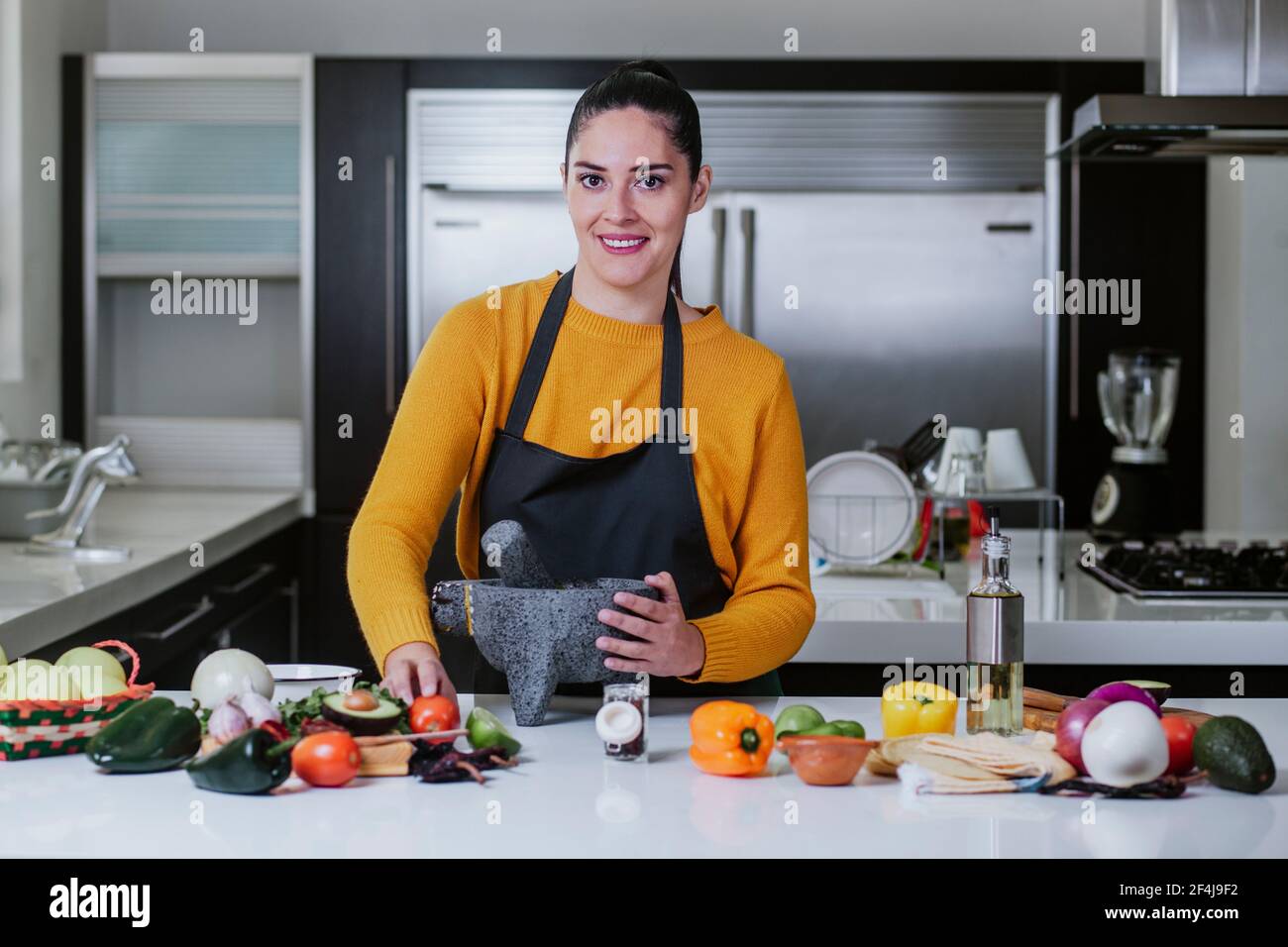 latin woman cooking mexican sauce food in kitchen at home in Mexico ...
