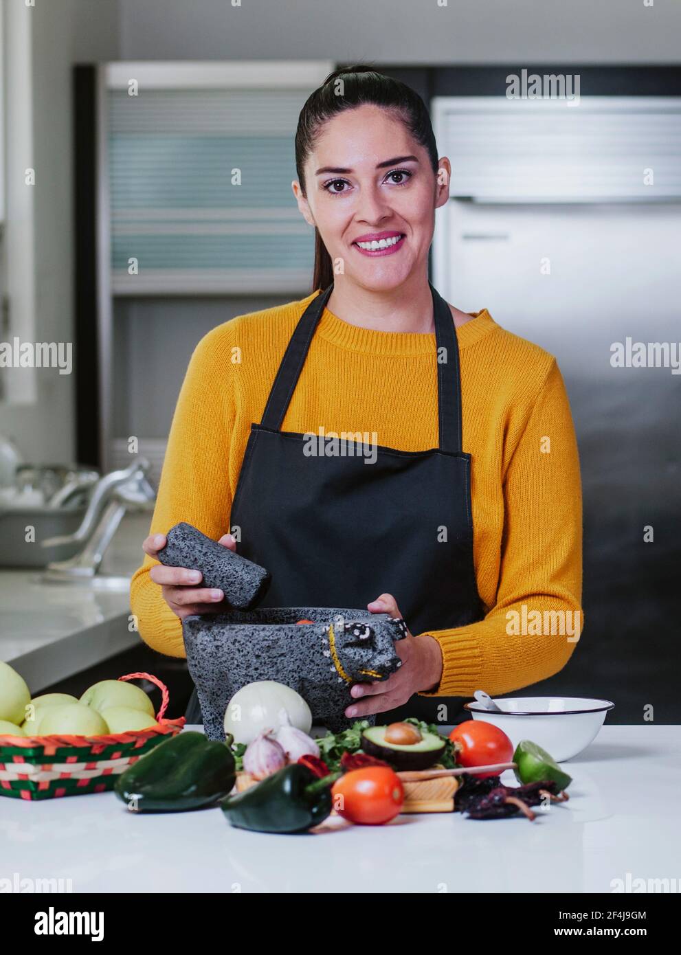 latin woman cooking mexican sauce food in kitchen at home in Mexico ...