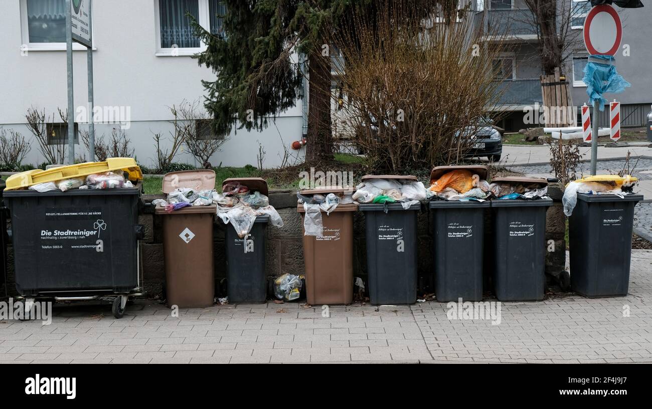 Kassel, Germany. 17th Mar, 2021. Garbage cans overflow in front of an ...