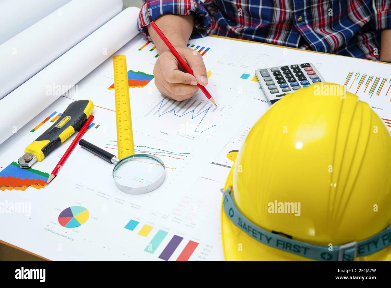 Architect or engineer working project accounting with graph with tools ...