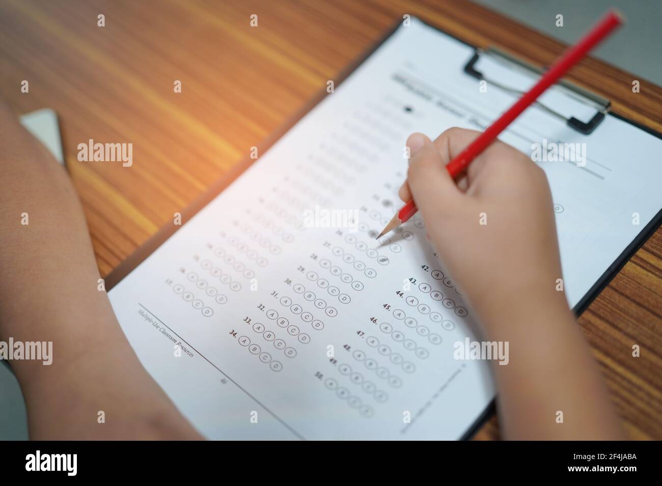 Asian children young kid write answer in a quiz examination test study ...