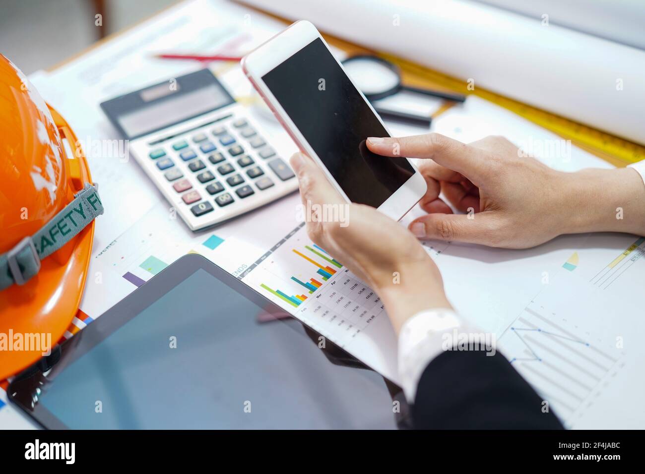 Architect or engineer working project accounting with graph with tools ...