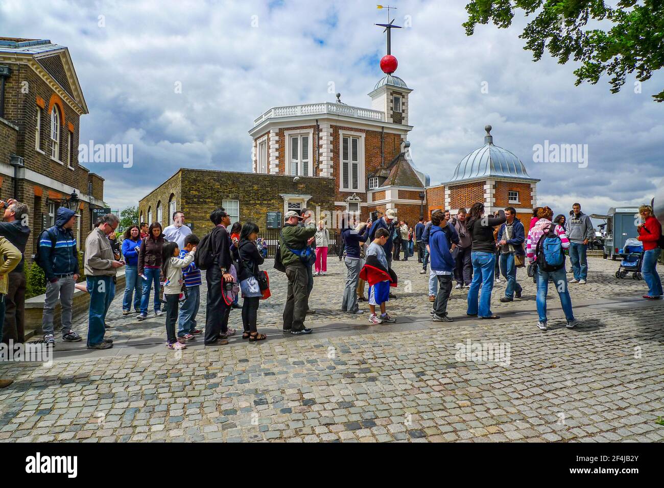 June 19 2010 - Greenwich, England. Visitors straddle the Prime Meridian ...