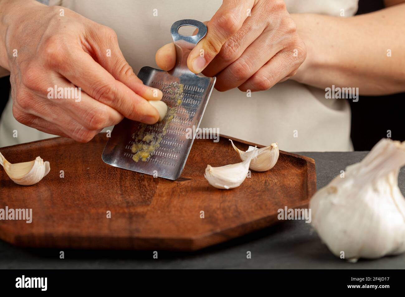 Woman grating garlic on metal hi-res stock photography and images - Alamy