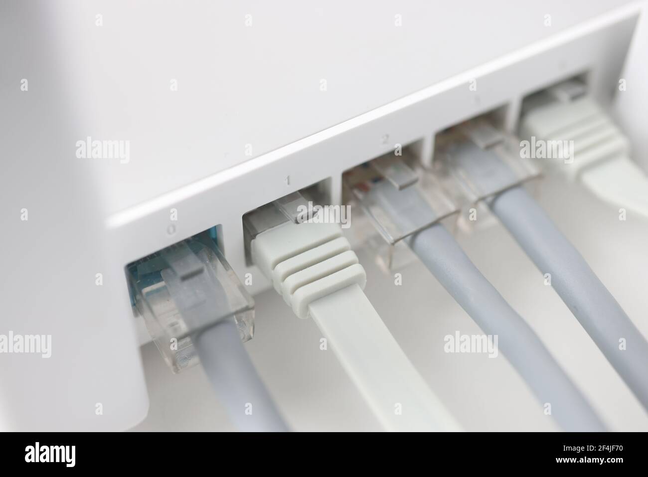 White internet router with connected wires closeup Stock Photo - Alamy