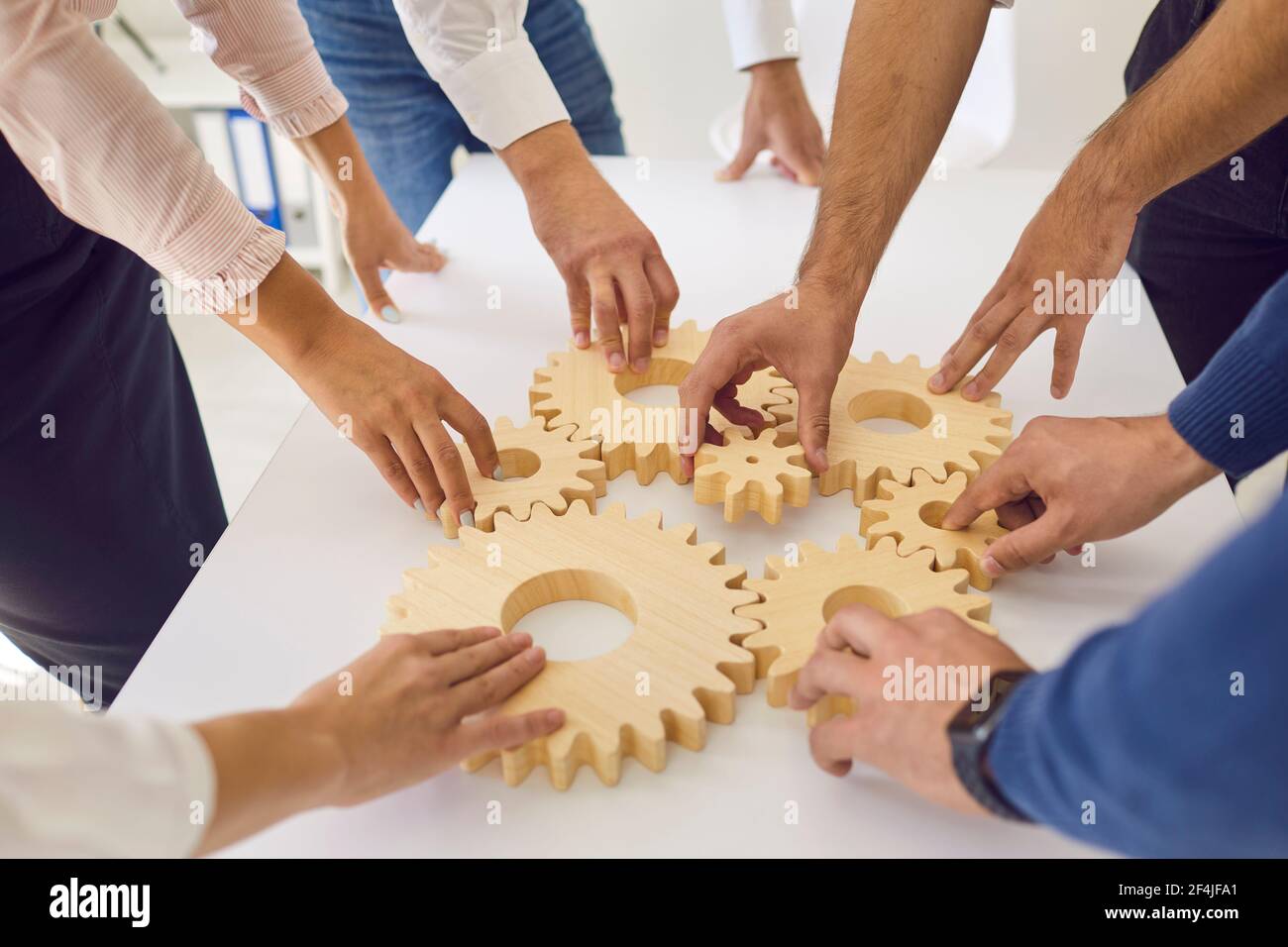 People join gearwheels around toy rocket as metaphor for teamwork and ...