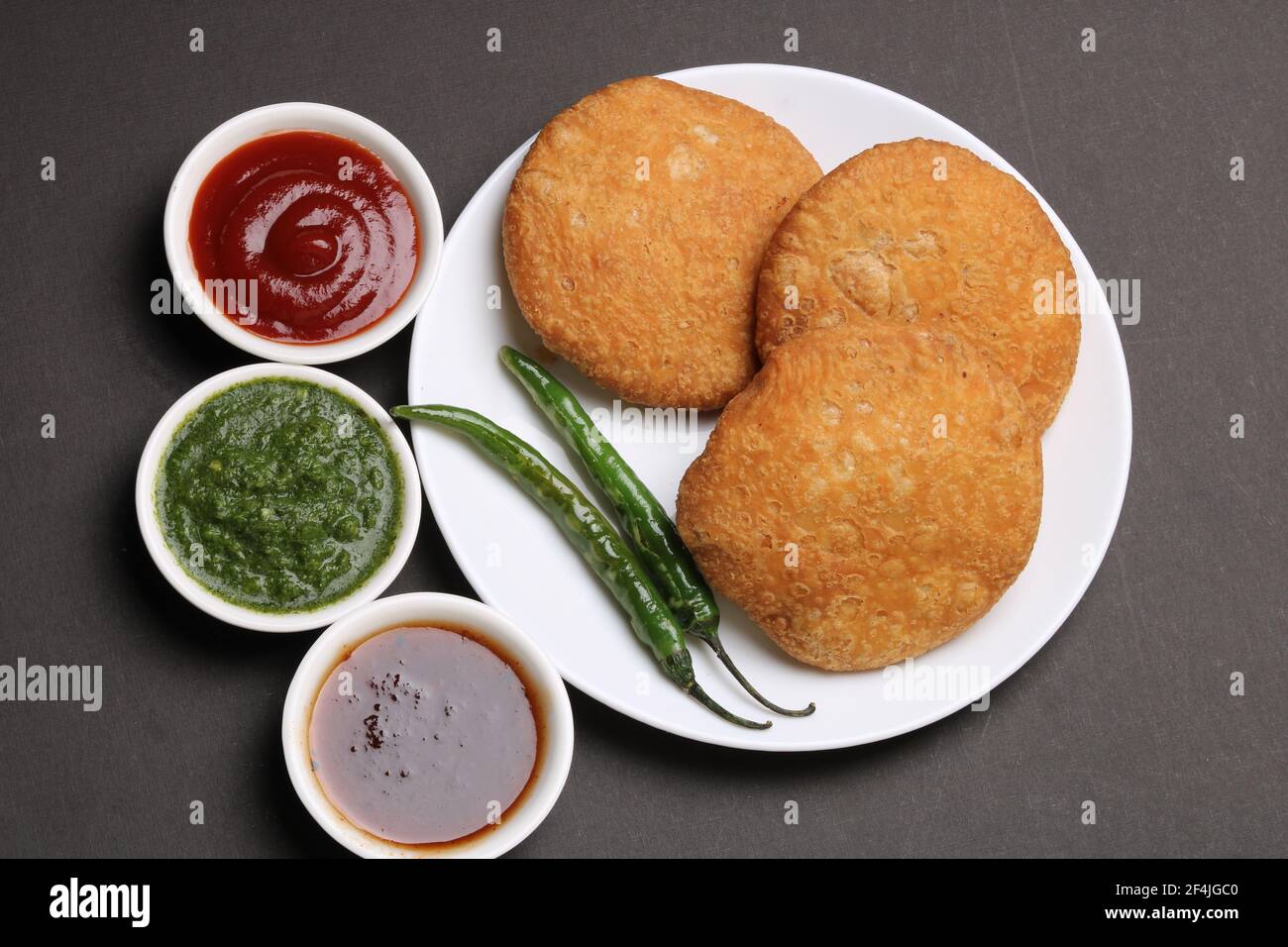 Indian snakes food kachouri or kachoudi kachori served with tamarind ...