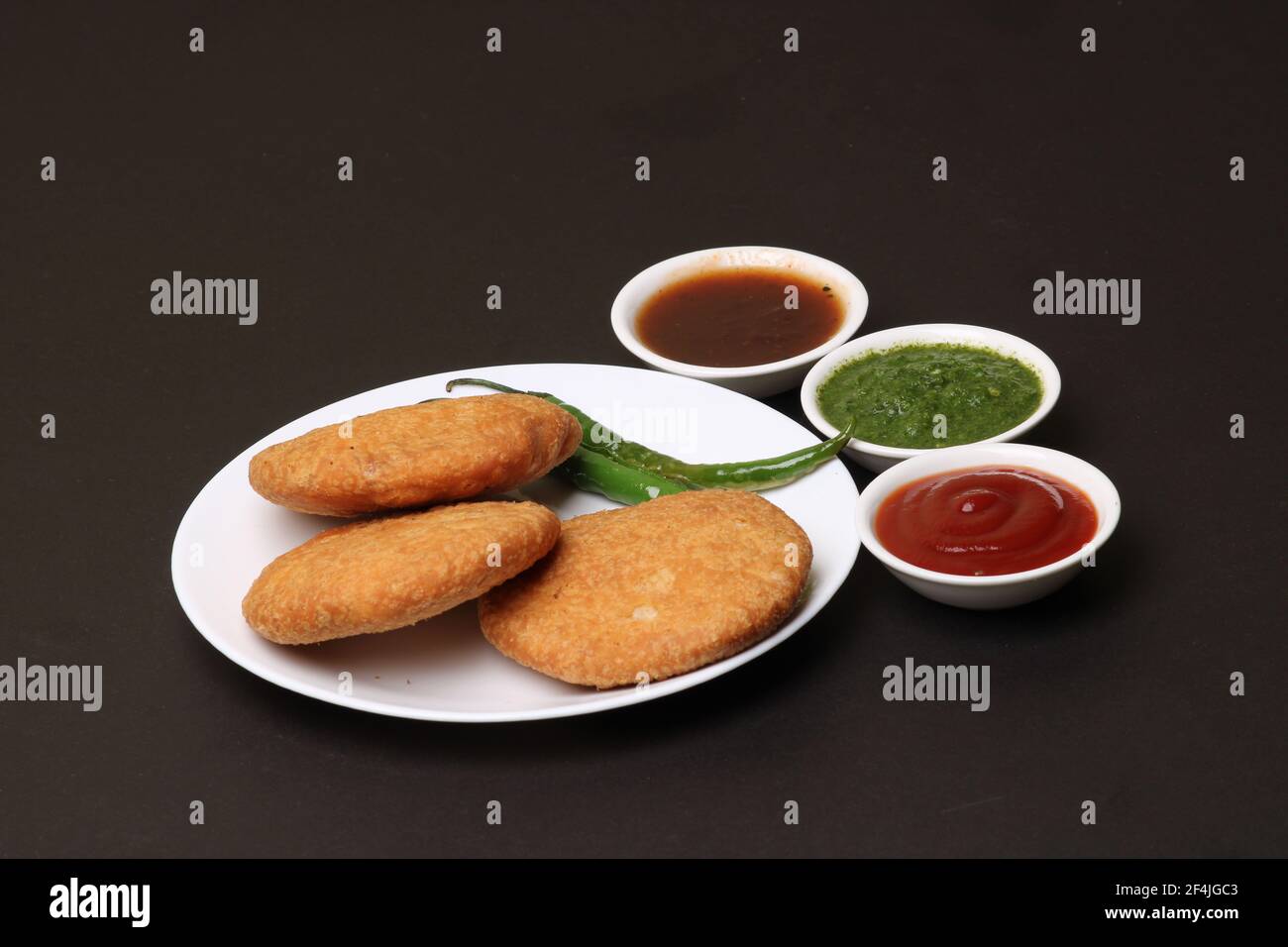 Indian snakes food kachouri or kachoudi kachori served with tamarind ...