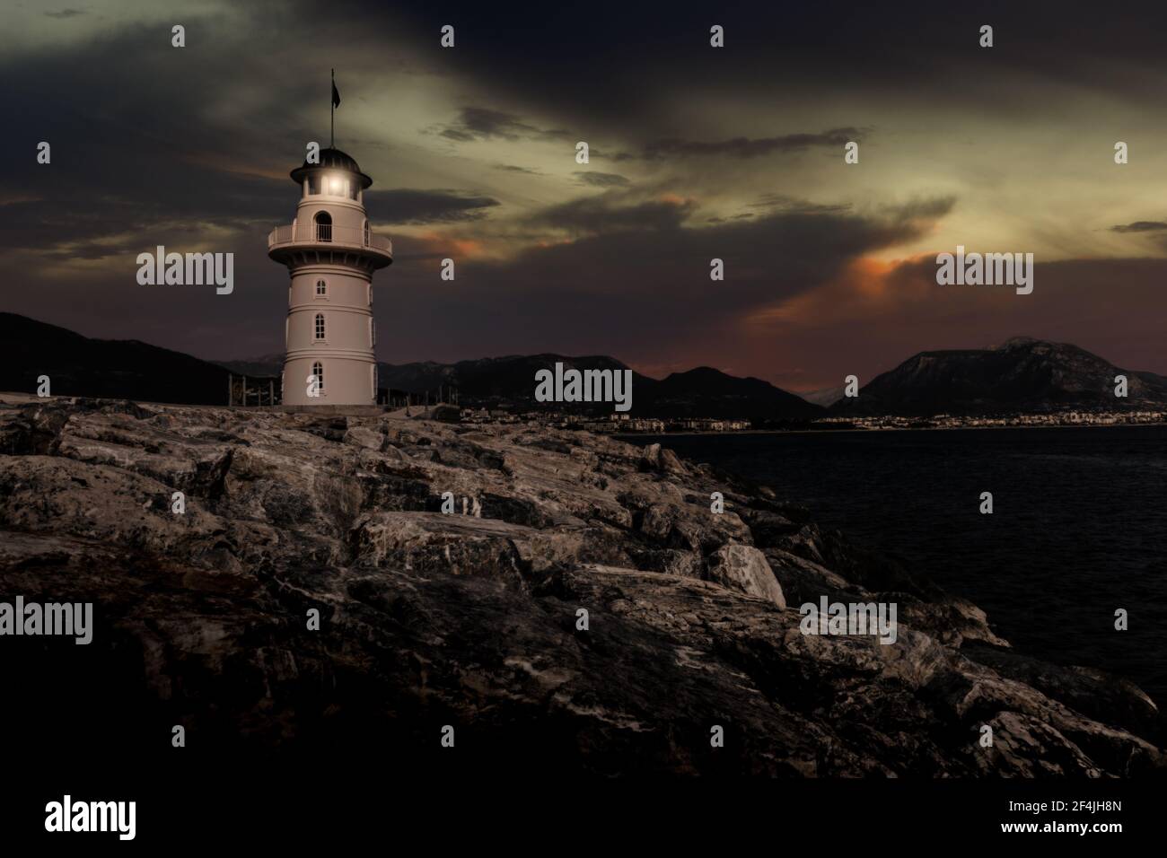 Lighthouse on a mediterranean coast at night Stock Photo - Alamy