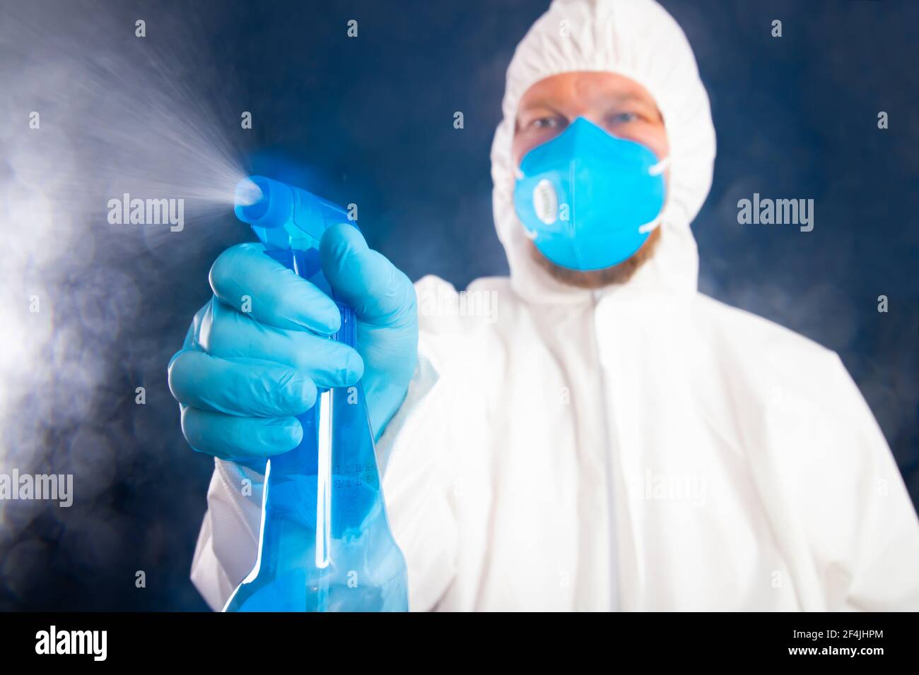 Conavirus pandemic. Man in full protected suit with disinfectant for ...