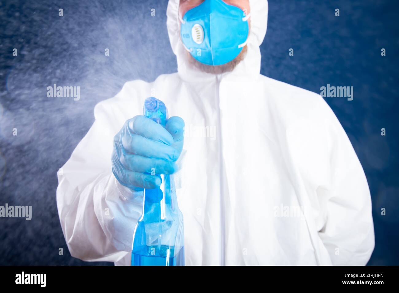 Conavirus pandemic. Man in full protected suit with disinfectant for ...