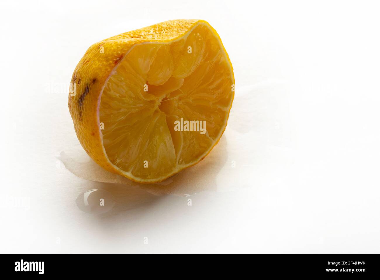 Squeezed lemon on a white background Stock Photo - Alamy
