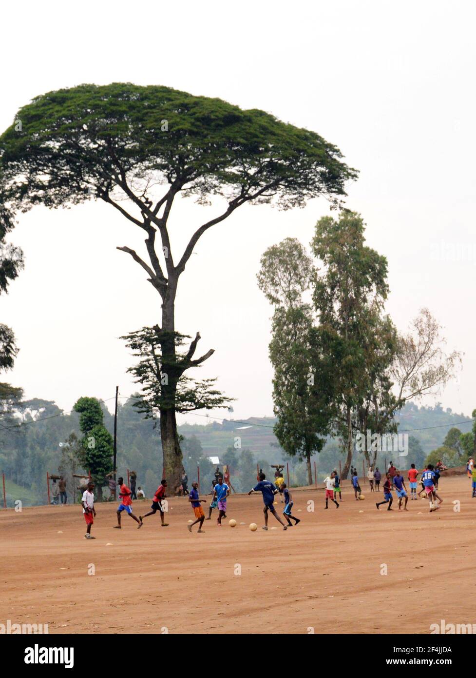 Rwandan men playing football Stock Photo - Alamy