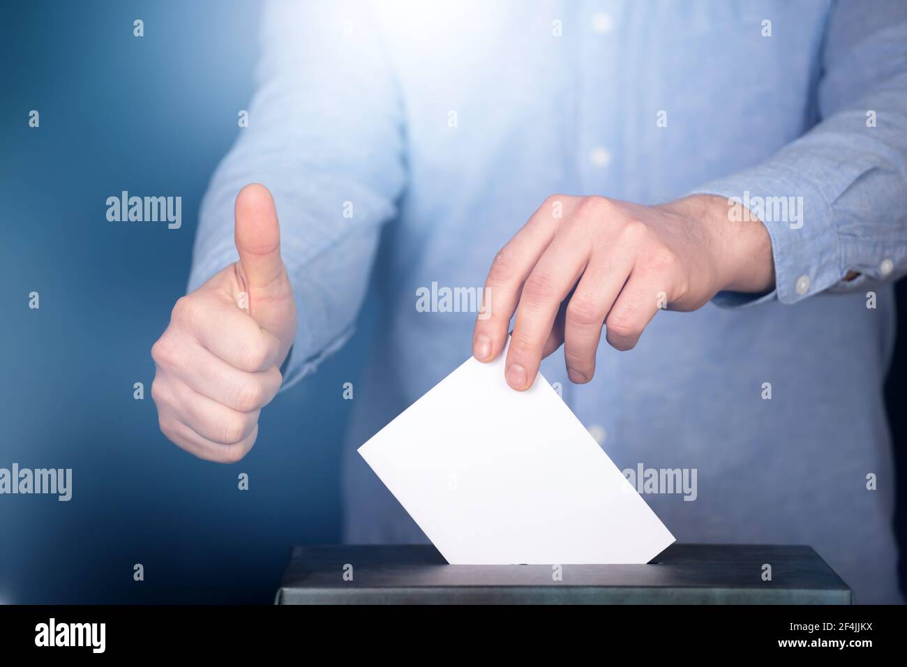 Hand of a voter putting vote in the ballot box. Election concept Stock ...
