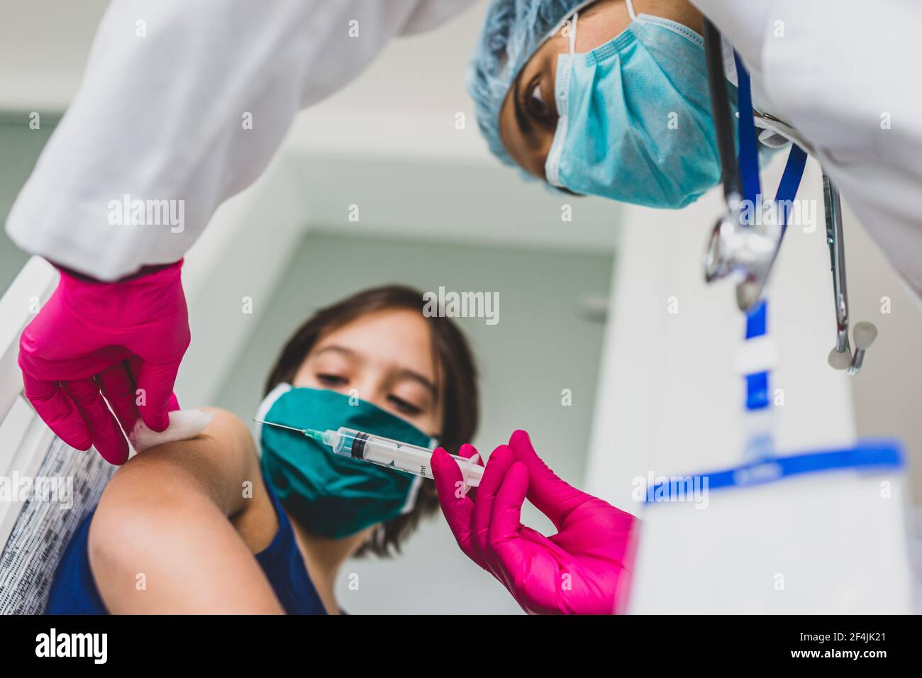 Little cute child with mask getting injection Stock Photo - Alamy