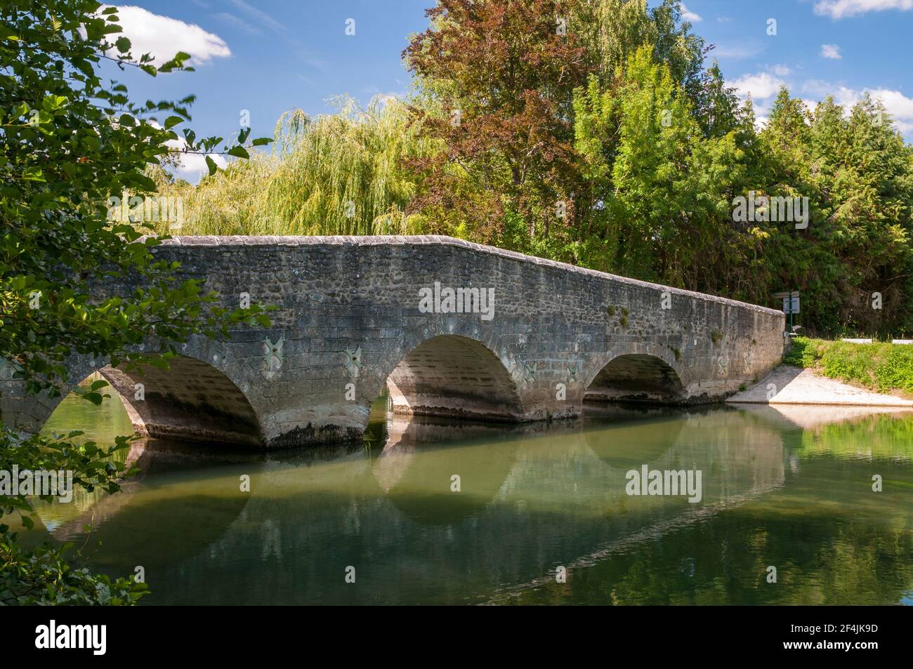 Old bridge from the 12th century (Pont Coude) on the Moulins canal ...