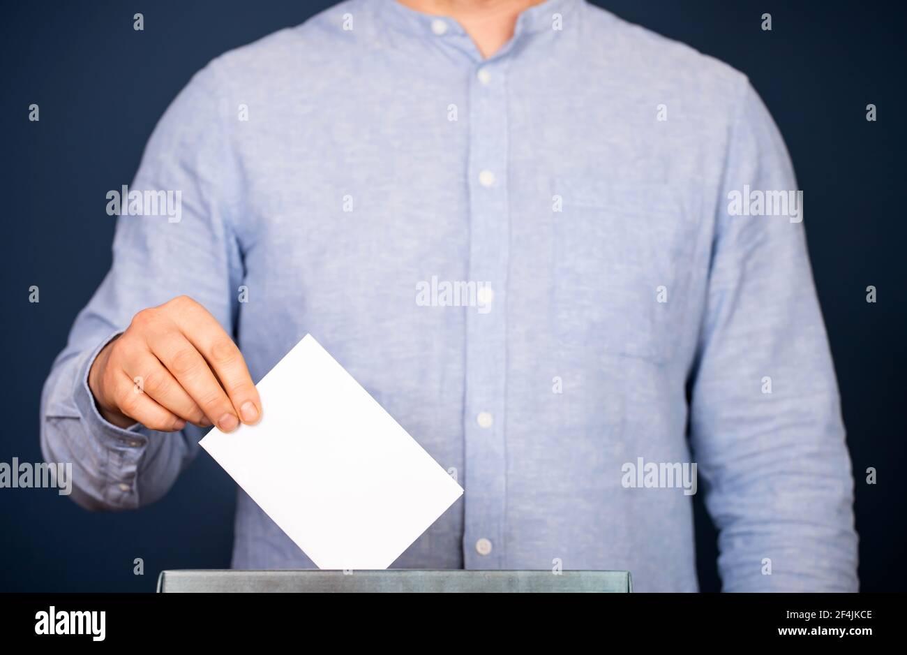Hand of a voter putting vote in the ballot box. Election concept Stock ...