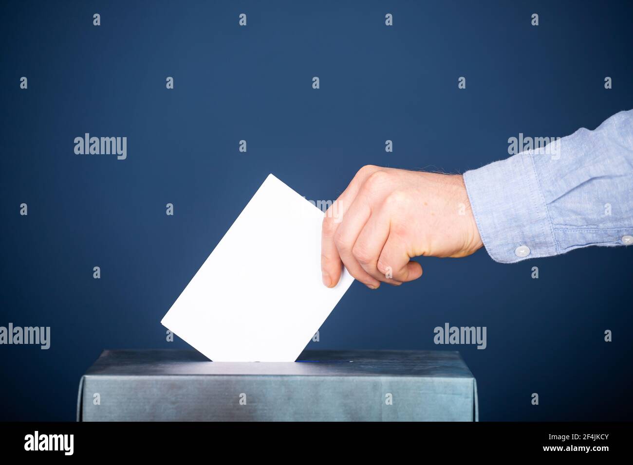 Hand of a voter putting vote in the ballot box. Election concept Stock ...