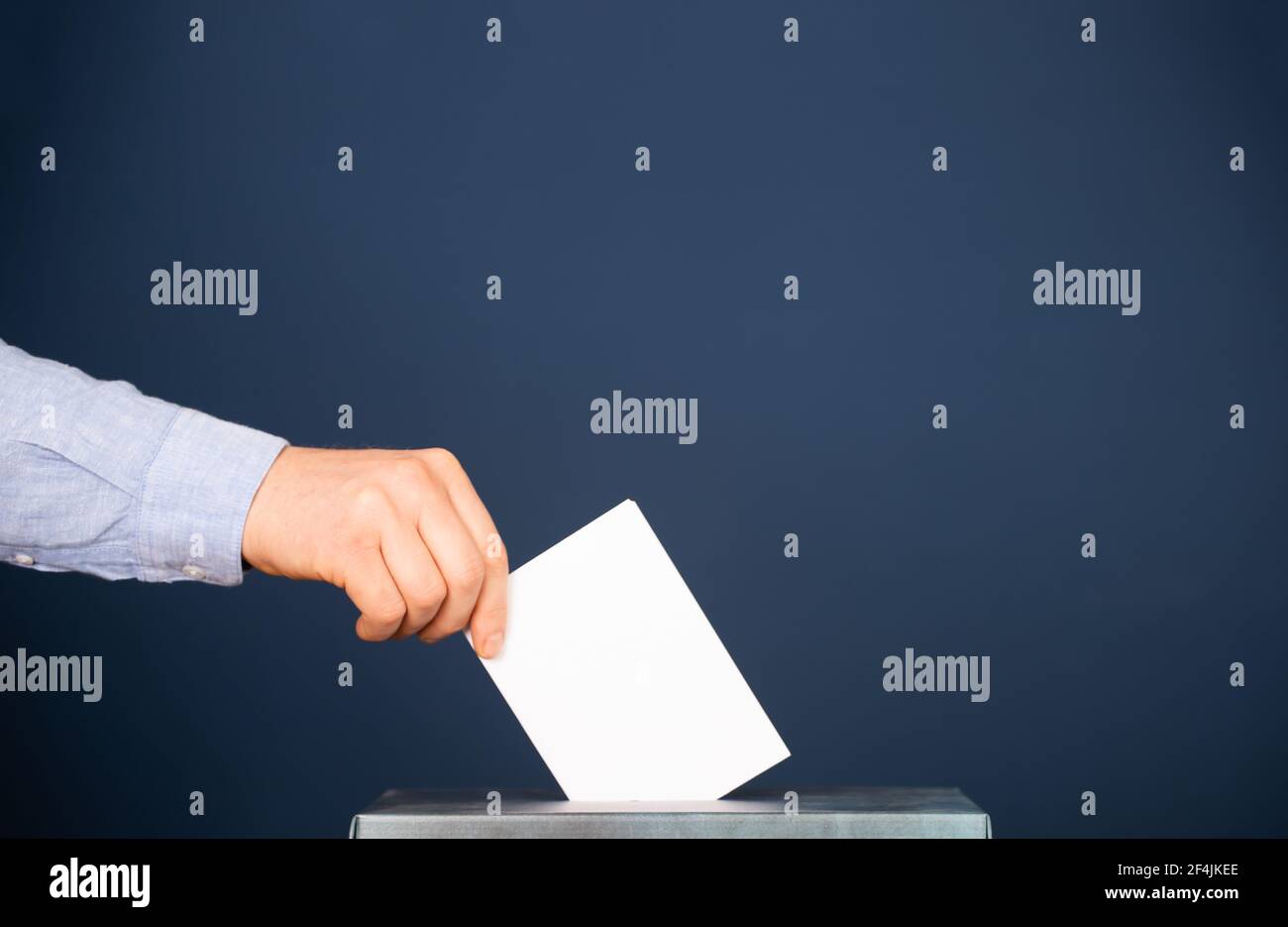 Hand of a voter putting vote in the ballot box. Election concept Stock ...