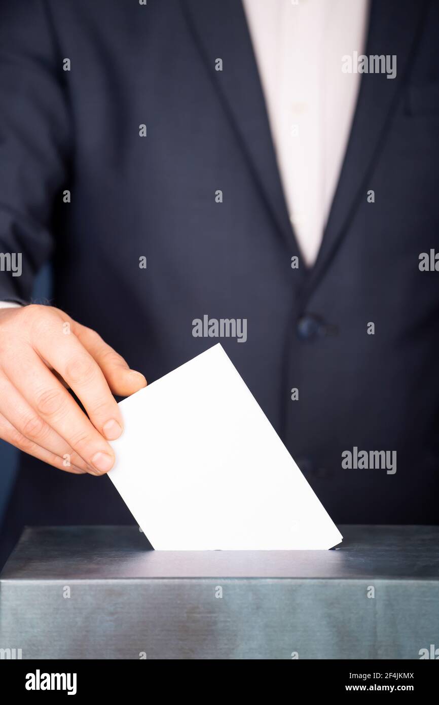 Voter putting vote in the ballot box. Election concept Stock Photo - Alamy