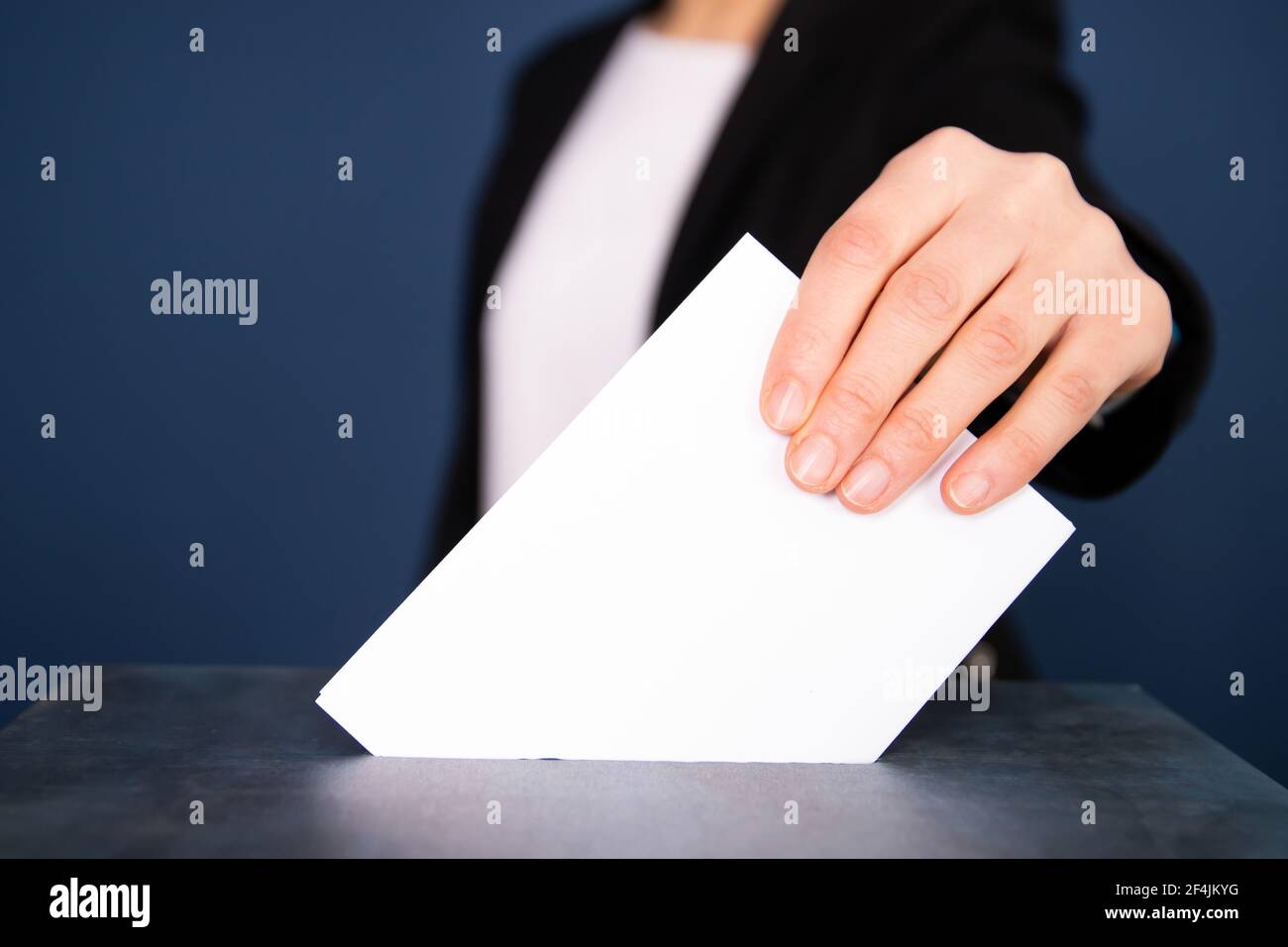Hand of a voter putting vote in the ballot box. Election concept Stock ...