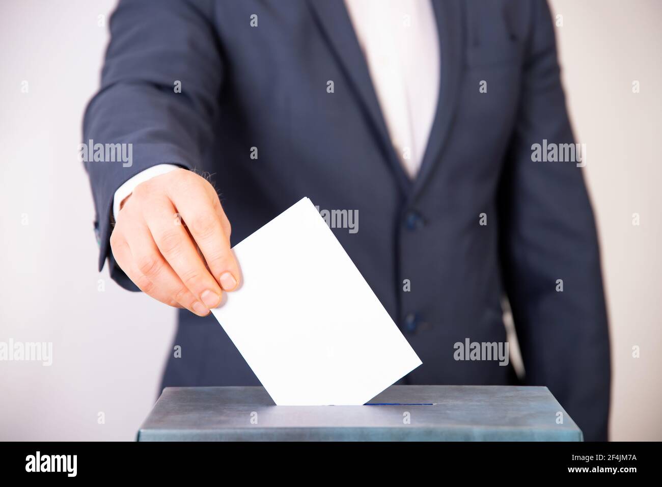Hand of a voter putting vote in the ballot box. Election concept Stock ...