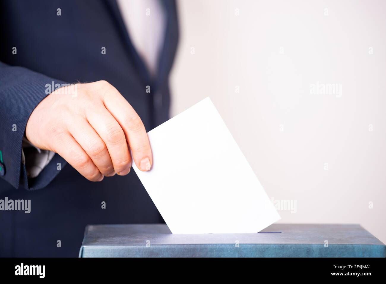 Hand of a voter putting vote in the ballot box. Election concept Stock ...