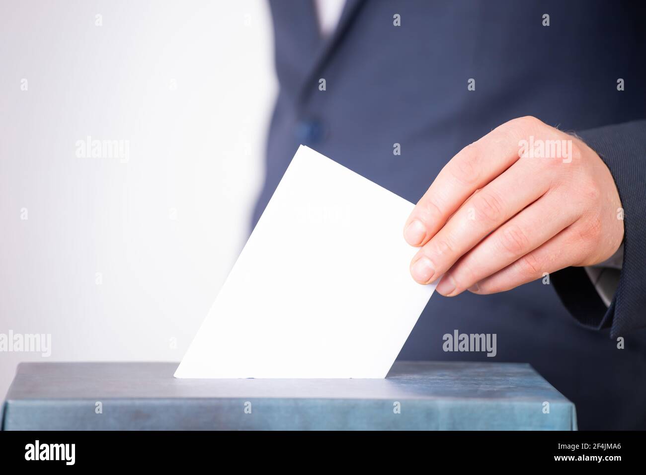 Hand of a voter putting vote in the ballot box. Election concept Stock ...