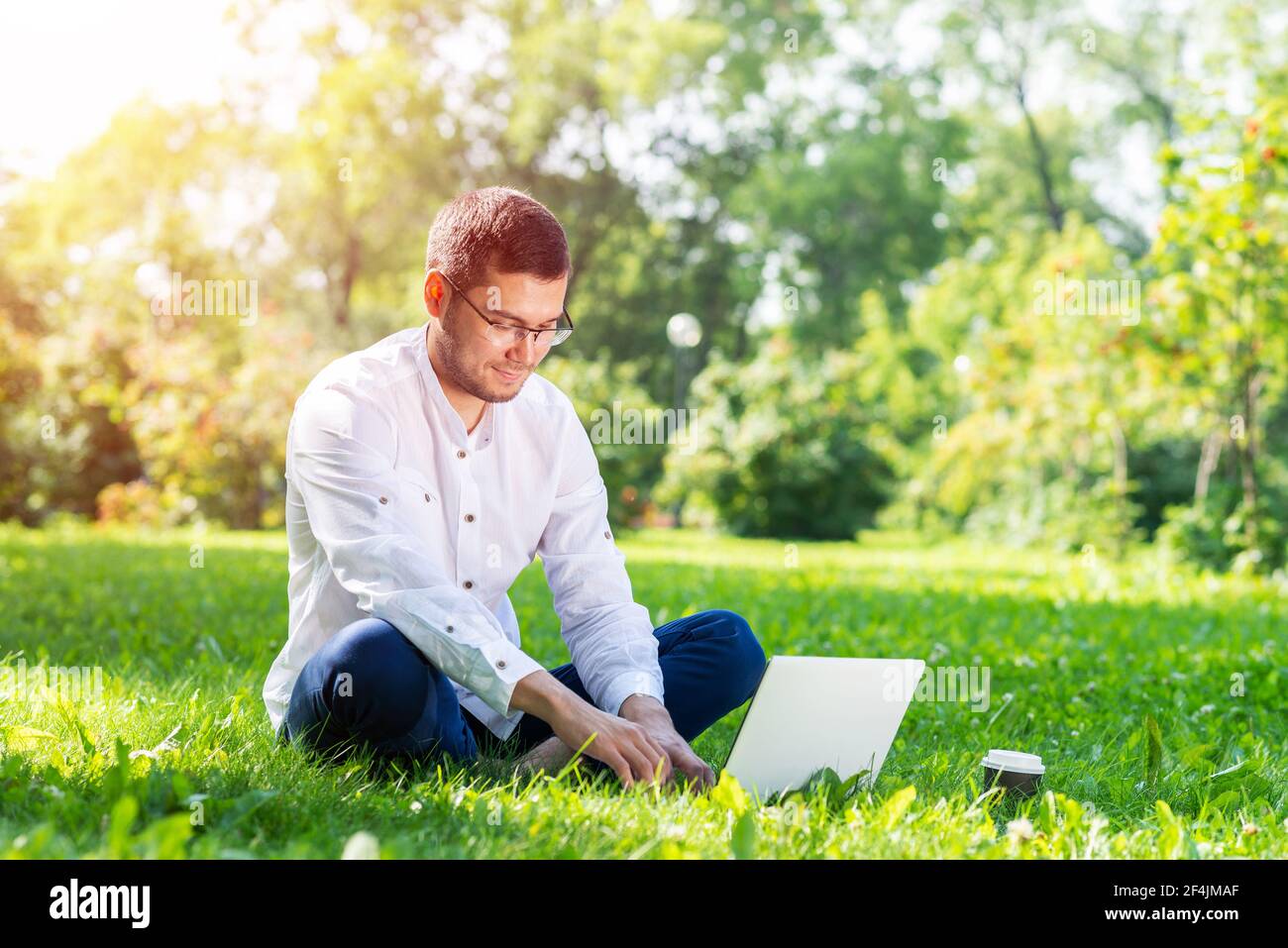 Young businessman using laptop computer Stock Photo - Alamy