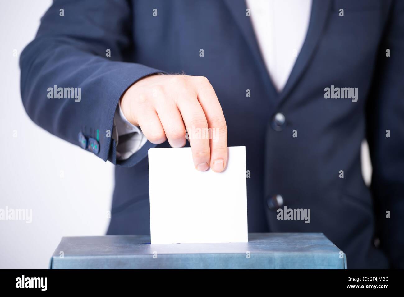 Hand of a voter putting vote in the ballot box. Election concept Stock ...
