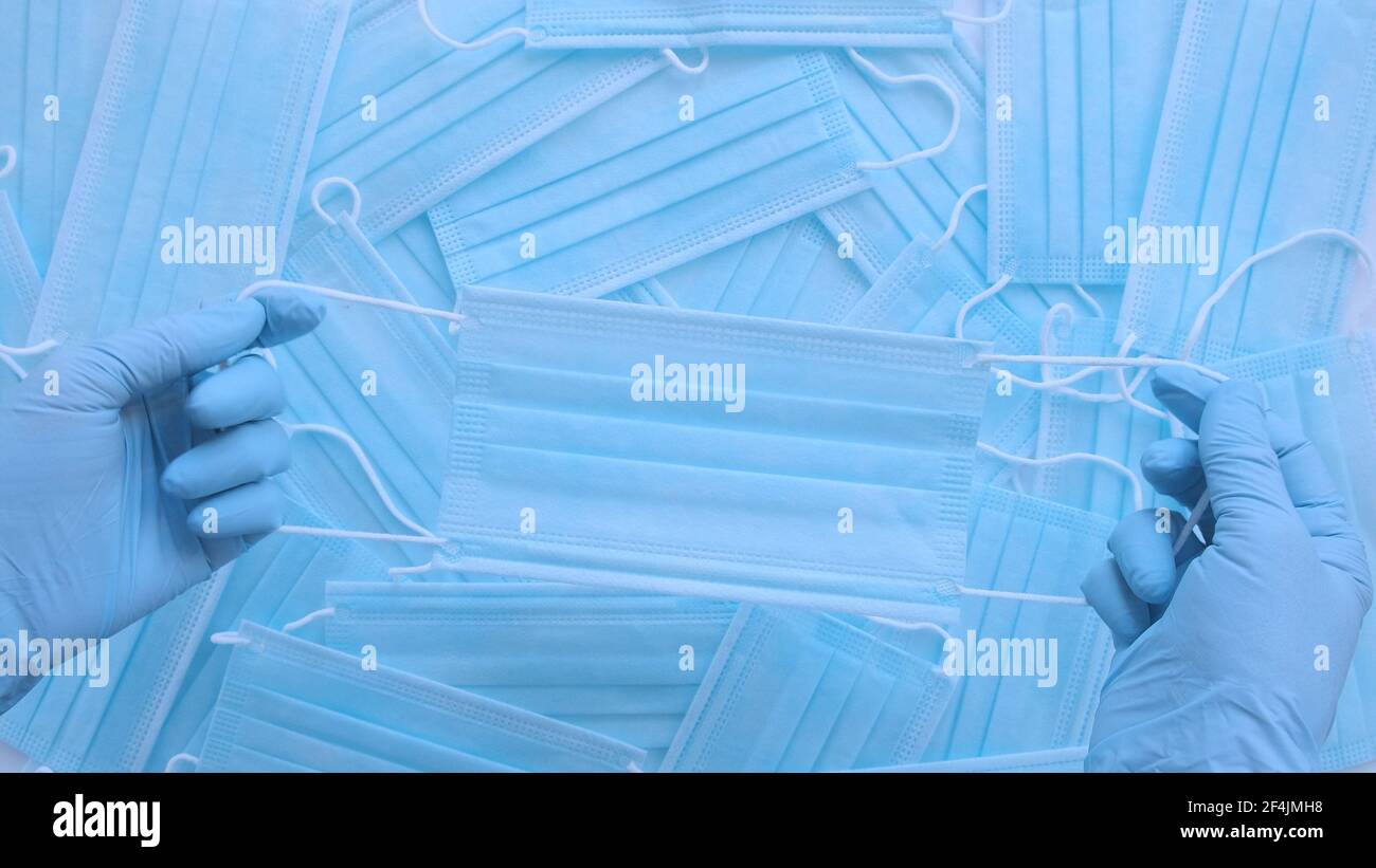 Medical masks. Doctor holds respiratory surgical face mask in hands ...