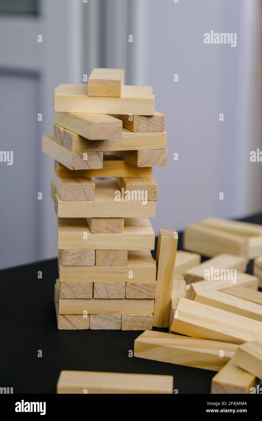 Building from wooden blocks. Wood blocks stack game with Hand on ...