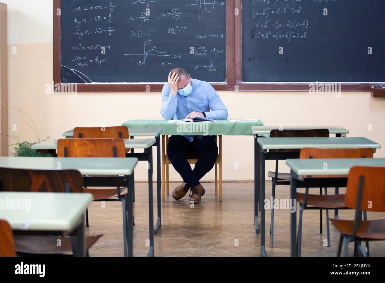 Teacher in the classroom wearing mask. Learning during coronavirus ...