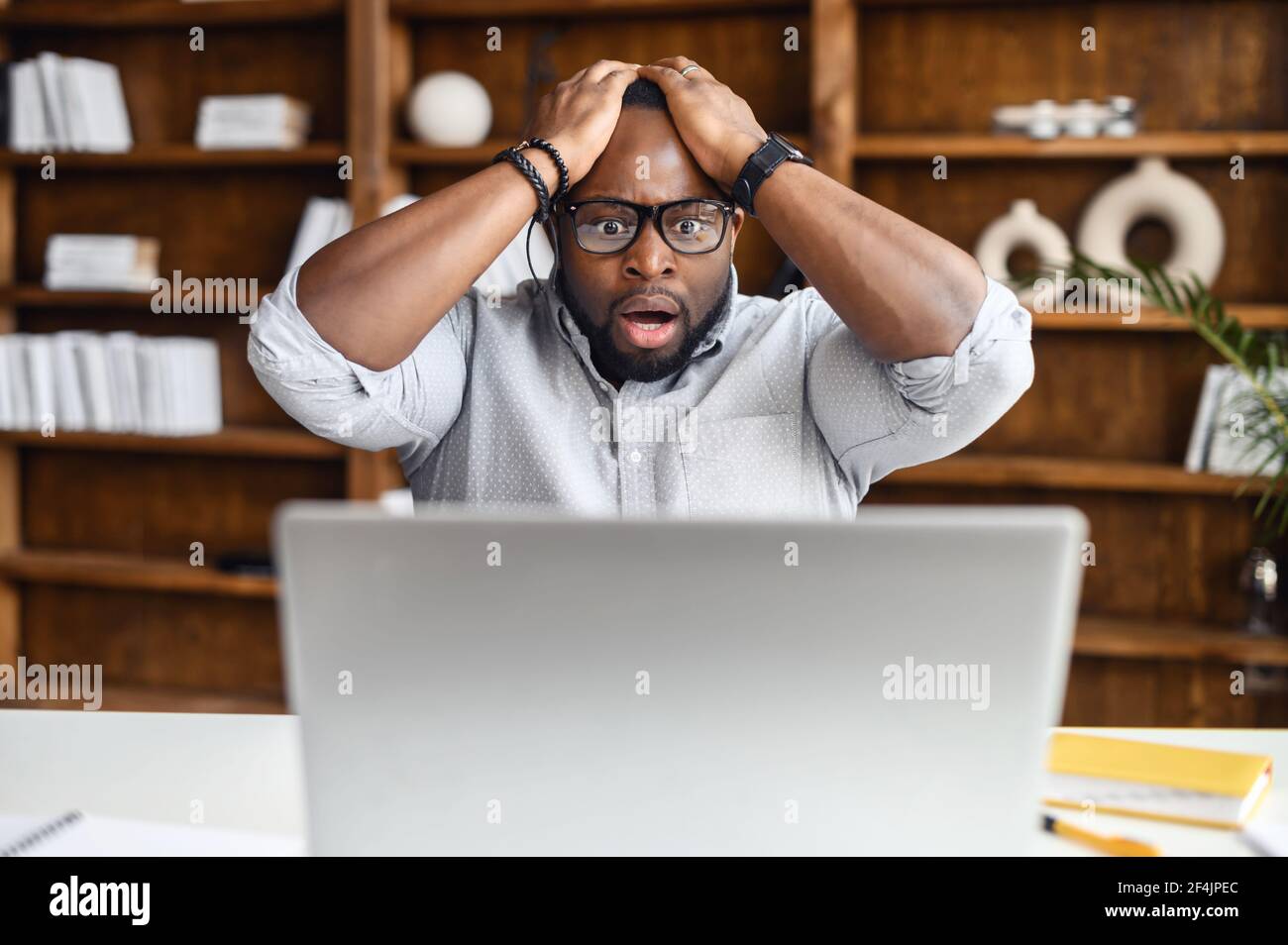 African American businessman received email with bad news, sitting at ...