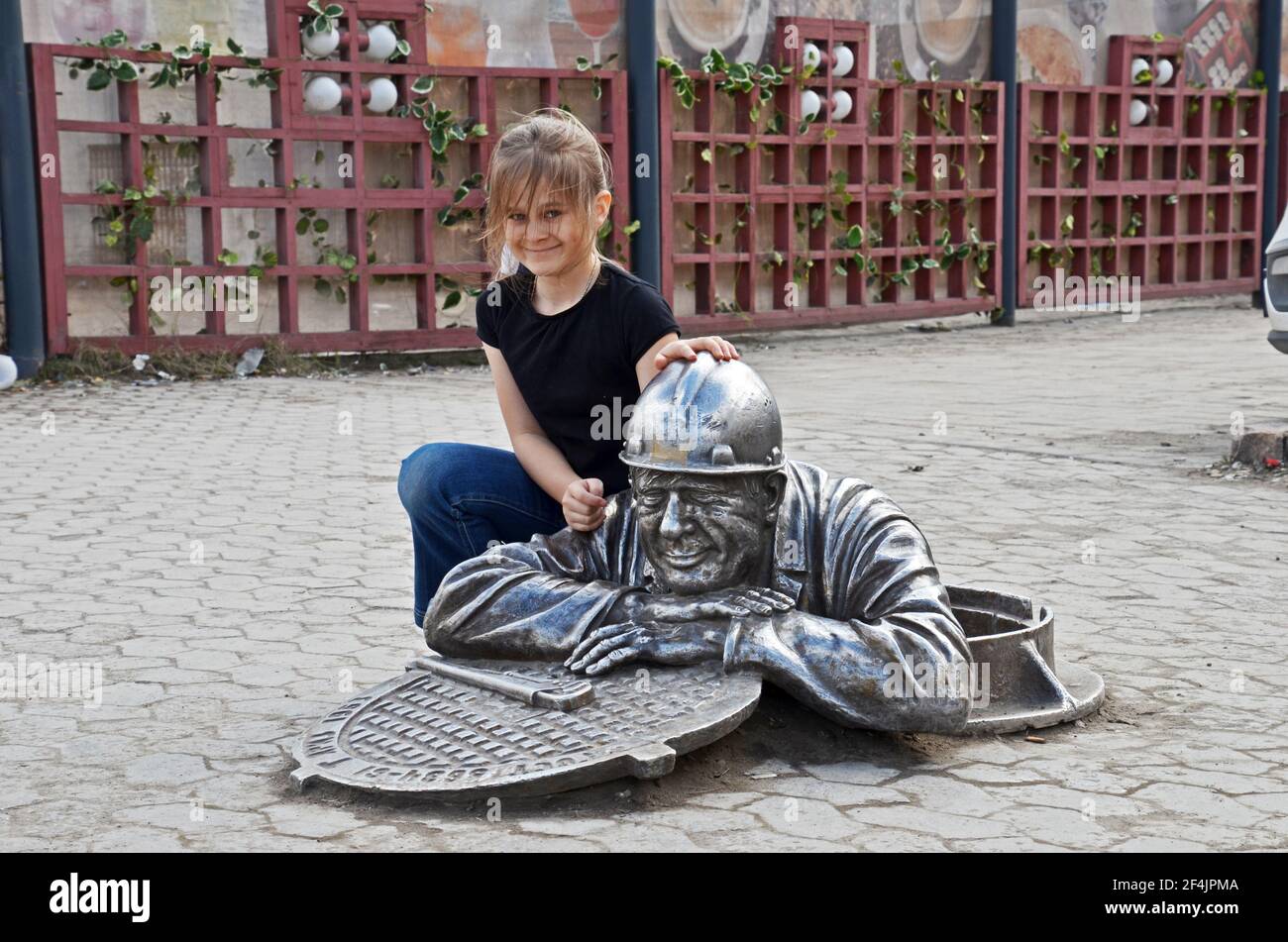 A child poses with street sculpture, Omsk, Siberia, Russia Stock Photo ...