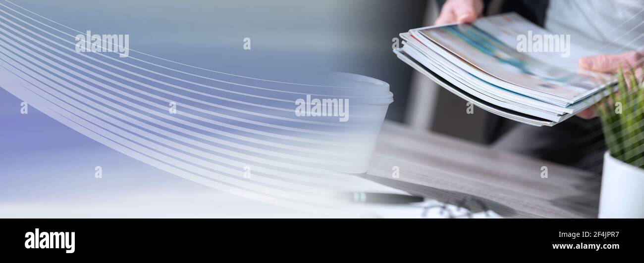 Male hands holding a stack of magazines; panoramic banner Stock Photo ...