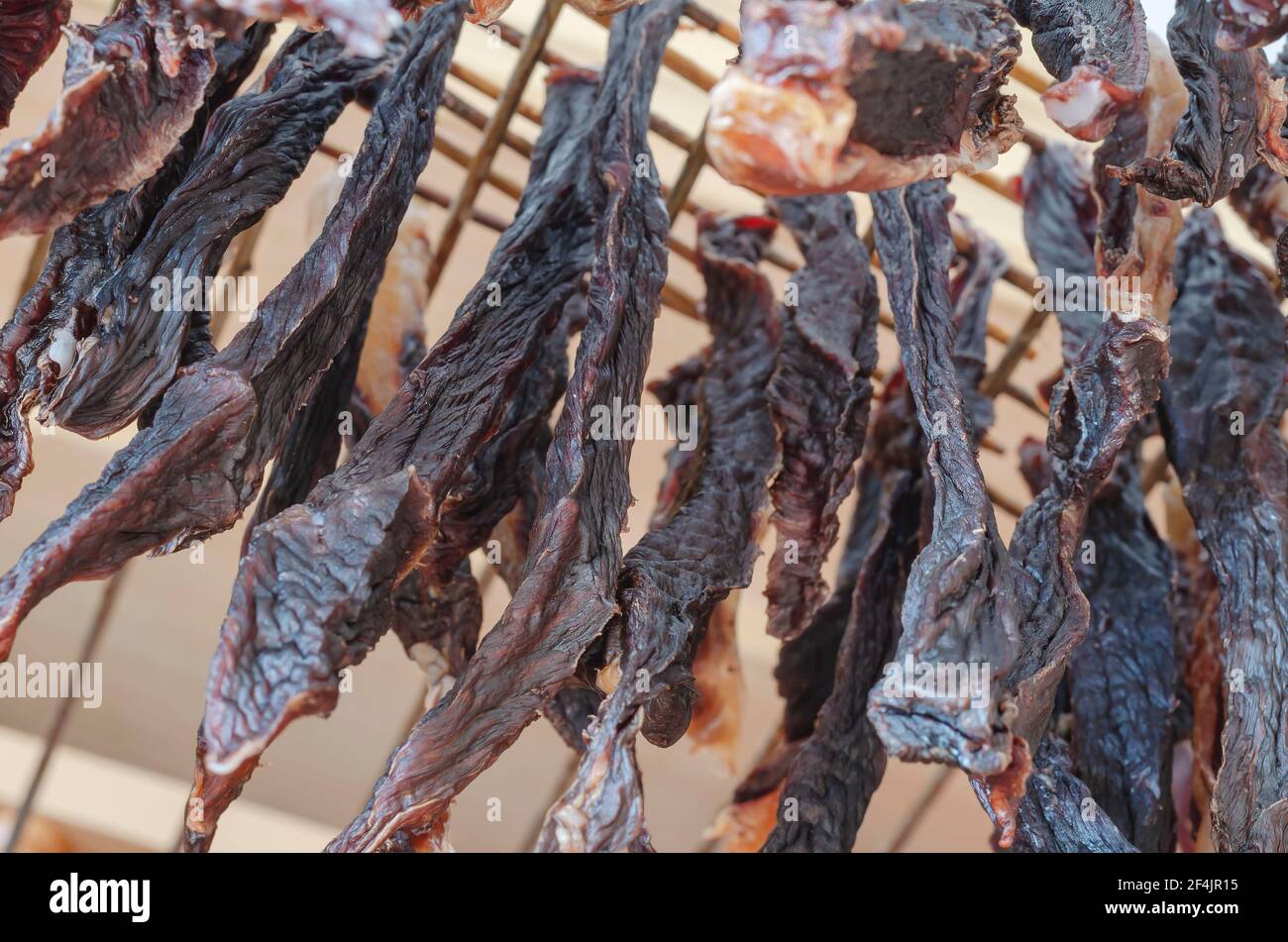 Hanging beef jerky close-up. Dried beef strips. Ready-to-eat treats ...
